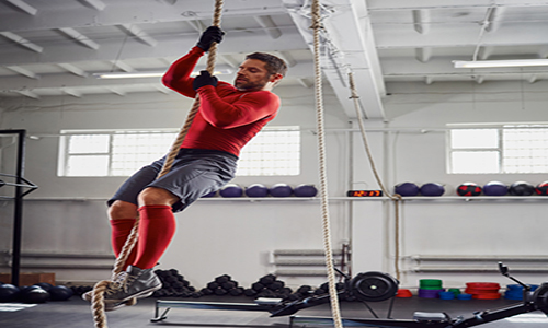 Fitness rope climb exercise at gym